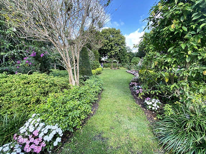 This manicured garden path practically begs you to stroll down it slowly, preferably while pretending you're in a period drama with excellent landscaping.