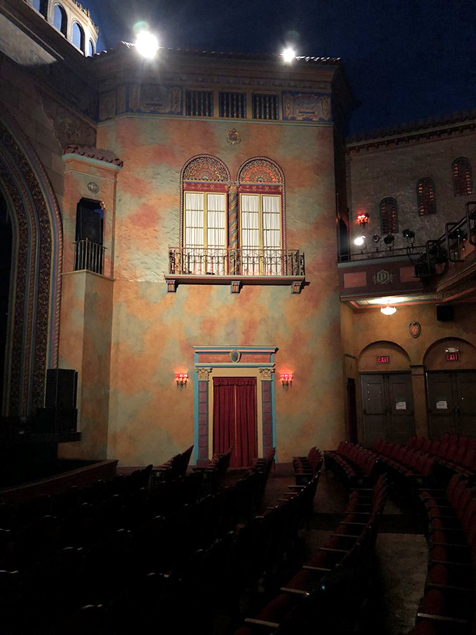 Mediterranean-inspired architectural details transform the theater walls into a European courtyard, making every seat feel like a vacation.