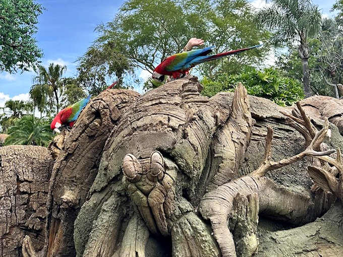 Vibrant macaws add living color to the landscape, perched on what appears to be ancient wood but is actually an engineering marvel.