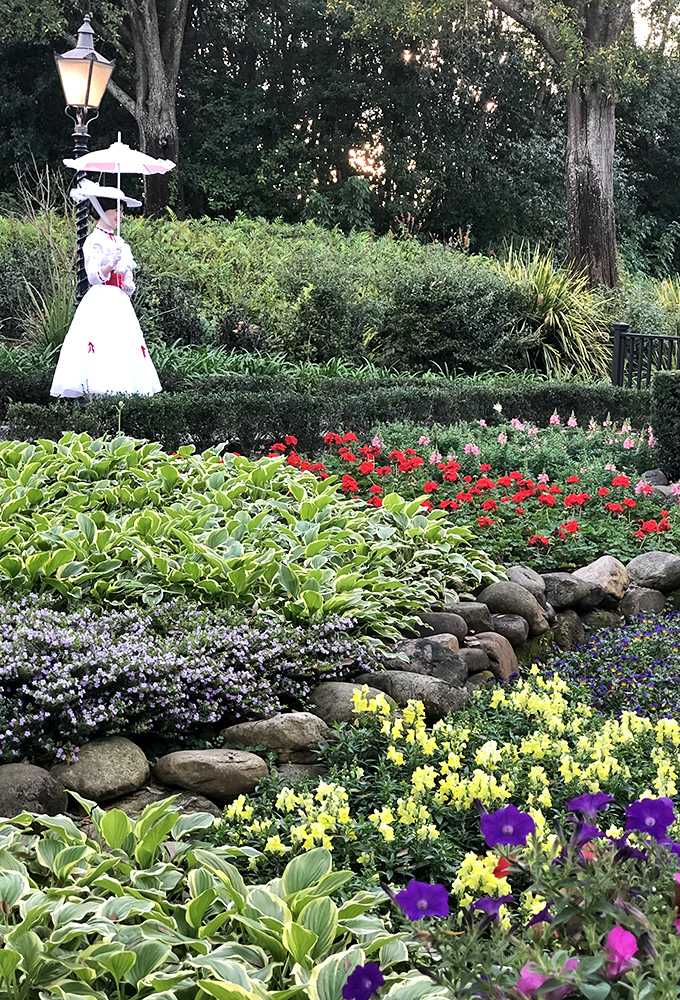 A magical nanny appears among the blooms! This garden scene captures the whimsy of Mary Poppins with its colorful flowers and perfect pathways.