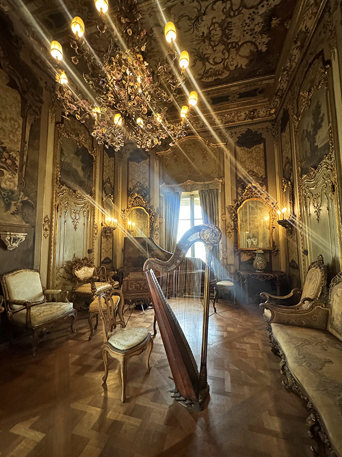 A music room so ornate that even playing chopsticks on that harp would somehow sound like a symphony, or at least feel appropriately dramatic.