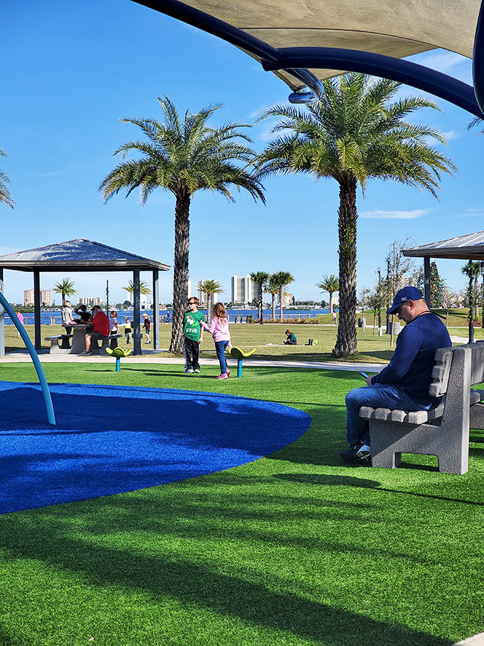 Families create memories at Riverwalk Park, where comfortable benches invite contemplation of the Halifax River's gentle flow.
