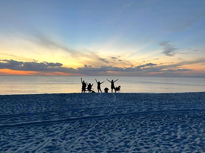 Silhouettes celebrating sunset: When the day's final light show begins, even strangers become unified in collective awe.