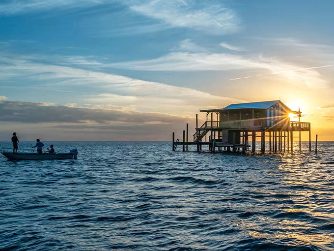Morning light bathes this sunburst-painted stilt house, its vibrant colors a beacon for boaters navigating Pasco's coastal waters.
