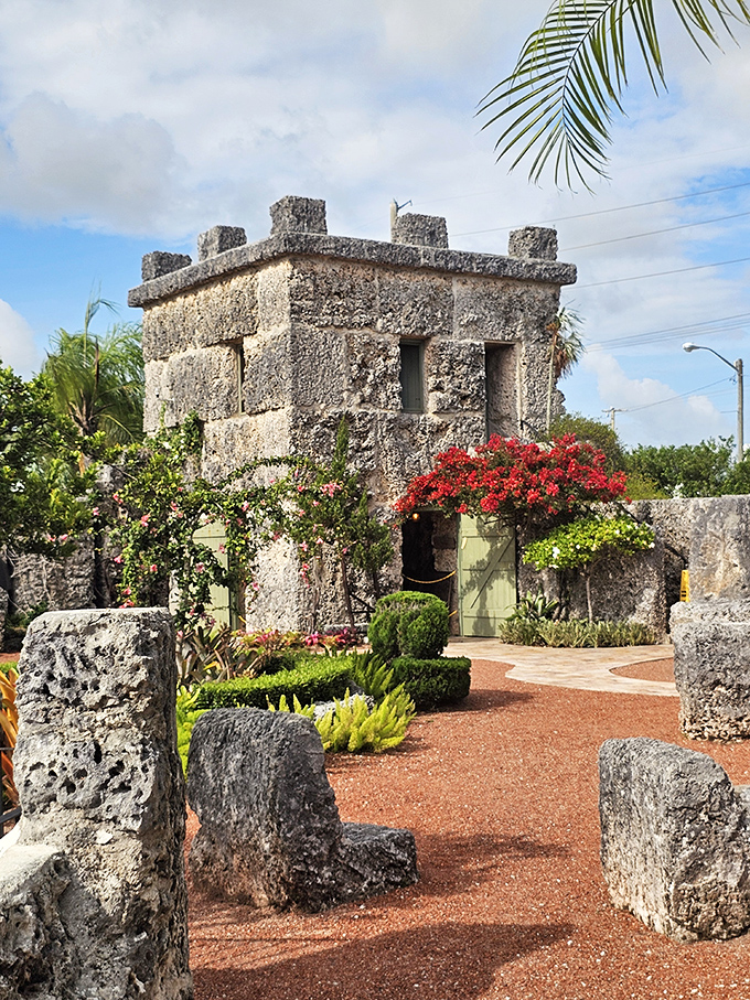 That's one charming fortress! The rugged coral stone walls softened by beautiful, bright red tropical bougainvillea bloom.