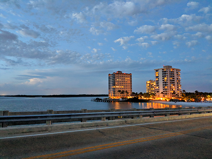 Coastal high-rises catch the day's final golden rays, standing like sentinels between civilization and the endless Gulf beyond.