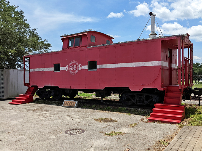 All aboard! This perfectly preserved red caboose complements the town's transportation-themed murals with authentic railroad history.
