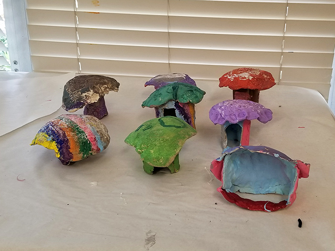 Whimsical ceramic mushroom houses bring fairy tale charm to the gallery, their bright colors and playful forms showcasing the joy of unbridled imagination.