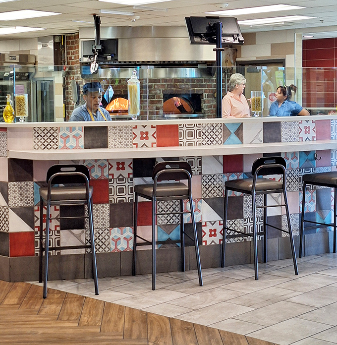 The colorful mosaic tile counter offers front-row seats to culinary action, where chefs (yes, actual chefs!) prepare made-to-order specialties.