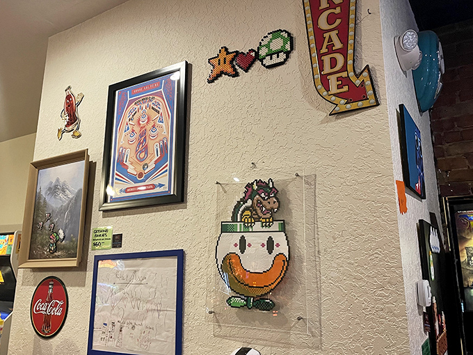 Pixel art decorations and gaming memorabilia transform brick walls into a gallery celebrating the artistic side of arcade culture.