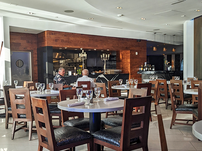 The dining room hums with conversation as patrons settle into wooden chairs, the warm lighting creating an atmosphere where food becomes an event.