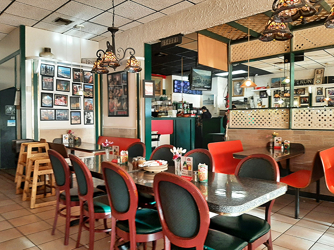 The dining area hums with conversation and satisfaction &ndash; red chairs and granite tables creating a comfortable setting for culinary adventures.