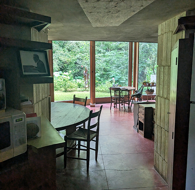 The dining area opens to nature's panorama – Wright understood meals taste better when served with a side of forest views.
