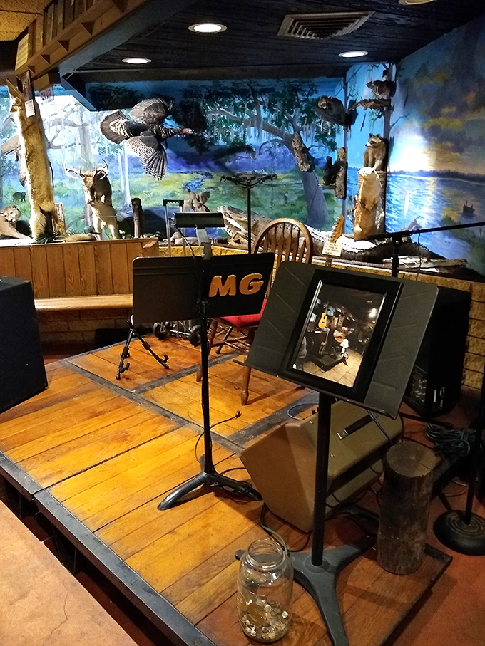 The entertainment area features a small stage where local musicians perform blues and folk music on weekend evenings.