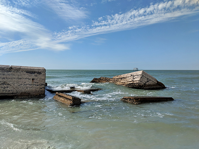 History crumbles beautifully into the sea, concrete remnants of military might now playground for fish and fascinating backdrop for snorkelers.