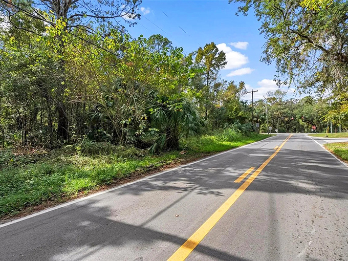 The long road stretches into the distance, a reminder that sometimes the best adventures are found on the paths less traveled.