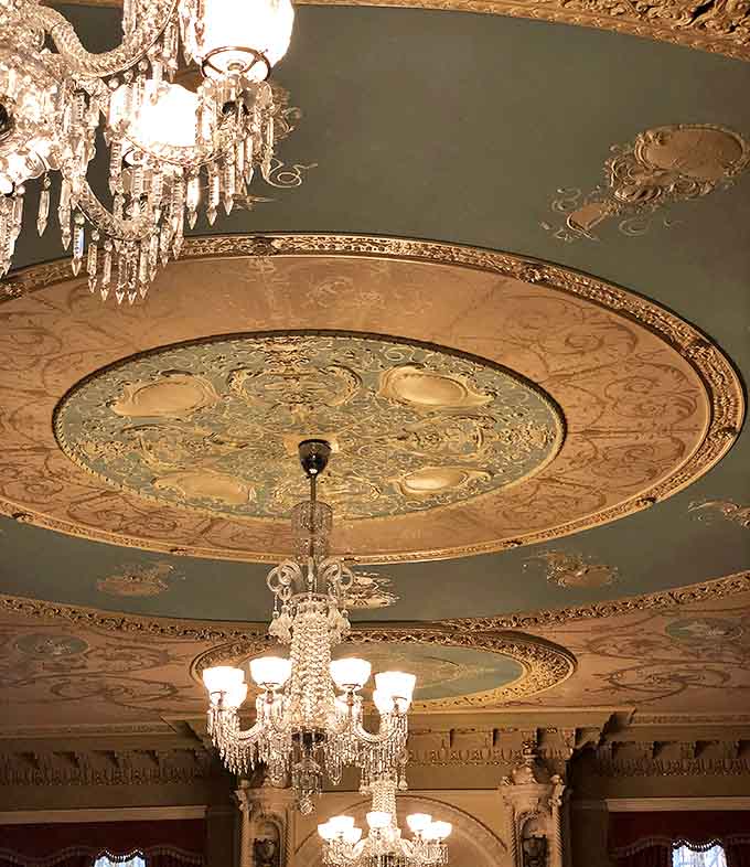 Look up! This ornate ceiling transforms a simple hallway into a gallery of craftsmanship that modern builders could only dream of replicating.