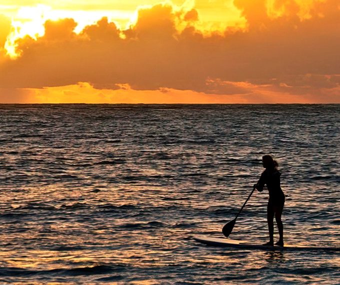Paddleboarding at sunset &ndash; or as locals call it, "mobile meditation with the added excitement of possibly falling in."
