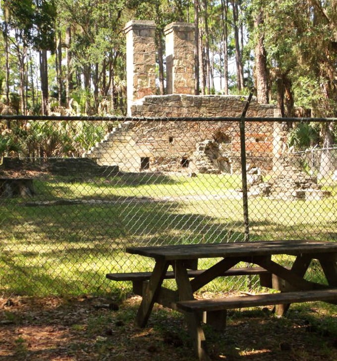 A simple picnic table invites visitors to sit and contemplate the contrast between modern leisure and historical industry.