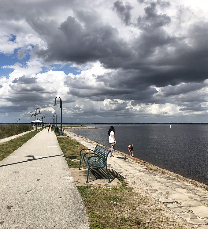 Families create memories along the lakefront path, where benches offer perfect pauses to absorb the panoramic water views.