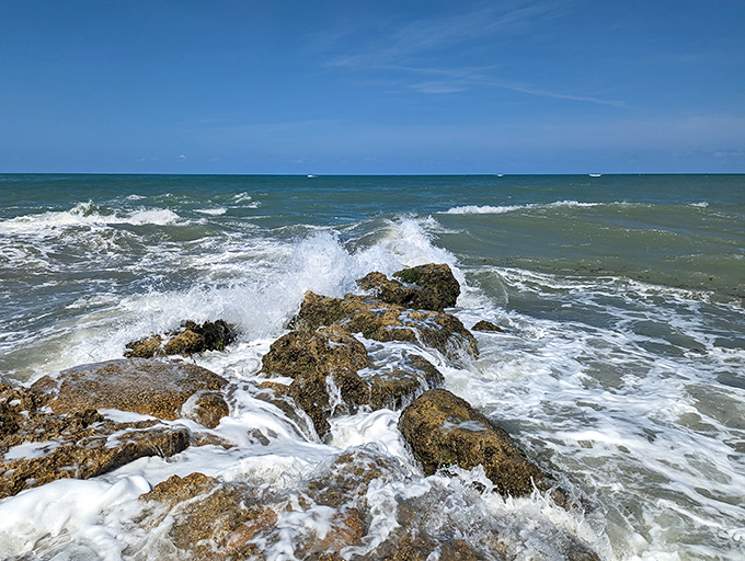 Waves crash dramatically against the rocks, nature's percussion section performing its timeless symphony.