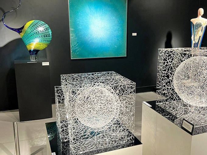 Crystal-clear cubes and spheres demonstrate glass art's mathematical precision, trapping light and reflecting it back in mesmerizing patterns.