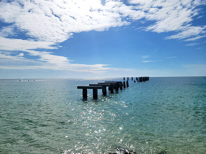 These weathered pilings tell silent stories of old Florida, standing like sentinels in waters where dolphins play and tarpon leap.