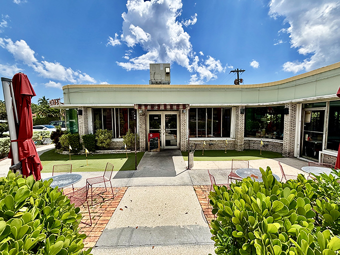 The charming outdoor seating area at Howley's invites you to enjoy your meatloaf under swaying palms, a uniquely Florida twist on the classic diner experience.