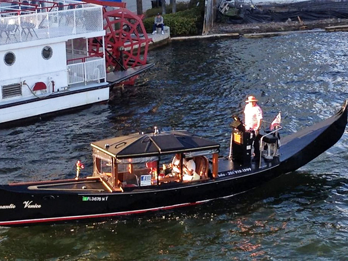 A gondolier guides visitors through Fort Lauderdale's waterways, offering a taste of Venice complete with traditional boats and serene canal views.