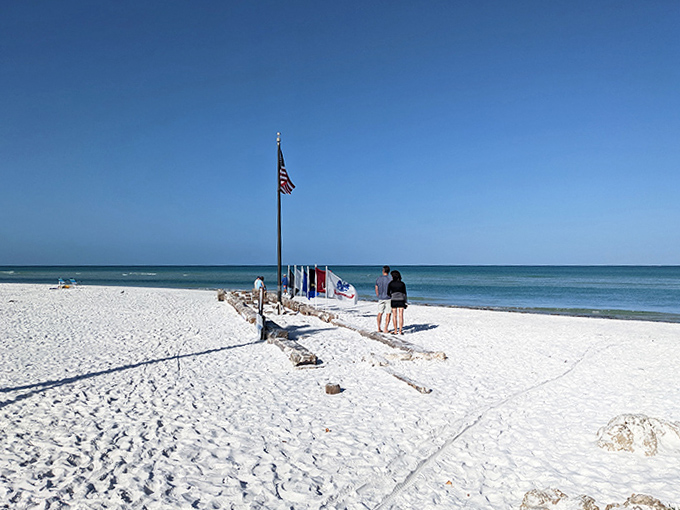 The famous quartz crystal sand of Siesta Beach glows brilliantly white against the backdrop of an endless blue sky and the turquoise Gulf waters.