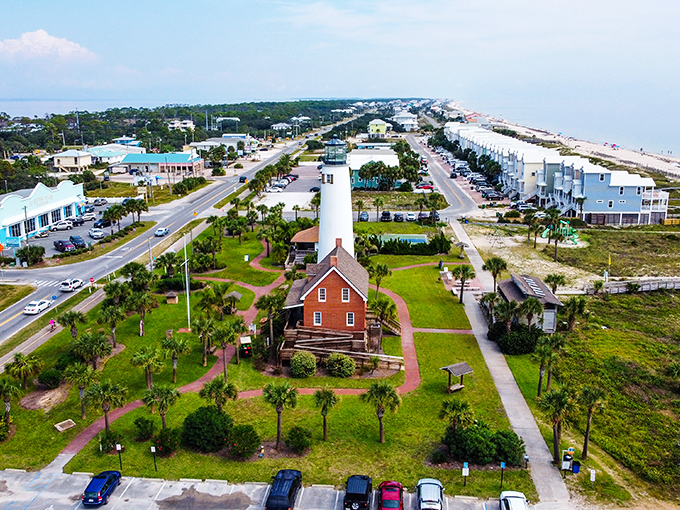 The historic lighthouse stands as a sentinel on St. George Island, surrounded by coastal homes and the island's famous sugar-white beaches.
