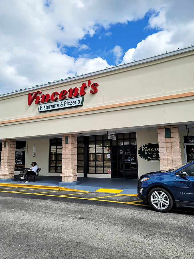 Vincent's bold red signage stands out against the Florida sky, promising authentic Italian flavors hiding in this unassuming strip mall location.