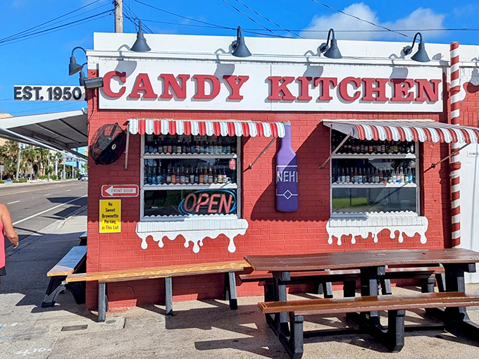 The iconic red brick exterior of Candy Kitchen stands like a sweet beacon on Gulf Boulevard, promising sugary treasures within since 1950.