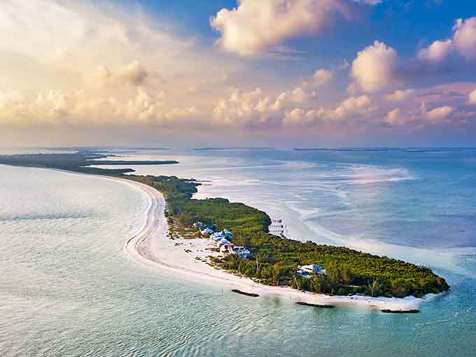 Captiva Island's pristine shoreline stretches like nature's welcome mat, where turquoise waters meet powdery white sand under cotton candy clouds.