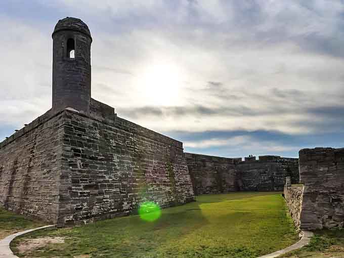 The imposing watchtower of Castillo de San Marcos stands sentinel against a moody sky, centuries of history captured in coquina stone.