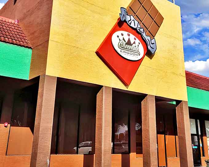 The vibrant yellow facade of Chocolate Kingdom beckons chocolate lovers with its oversized candy bar sign – subtlety isn't on the menu here.