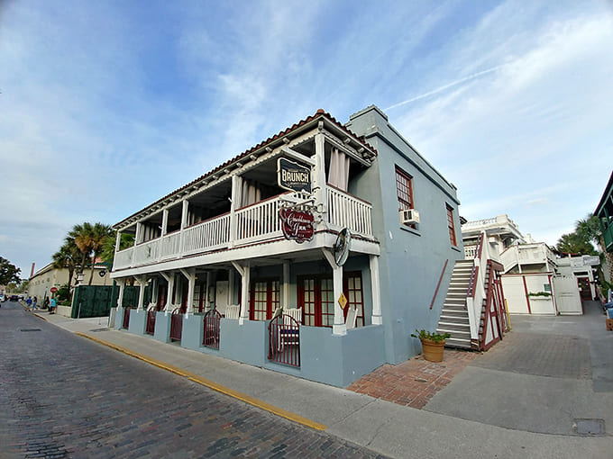 The pale blue Mediterranean Revival exterior looks charming by day, but those shadows get interesting after dark.