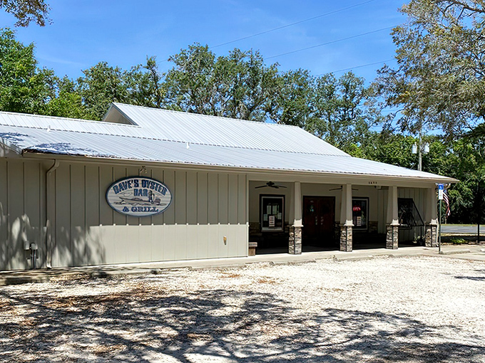 A humble white building with metal roof stands quietly in Gulf Breeze, hiding seafood treasures within like a culinary speakeasy.