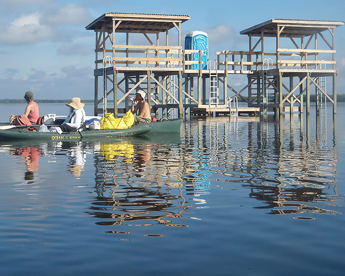 Wooden sentinels rising from the water, Shark Point Chickee offers wilderness luxury where alligators are your neighbors.