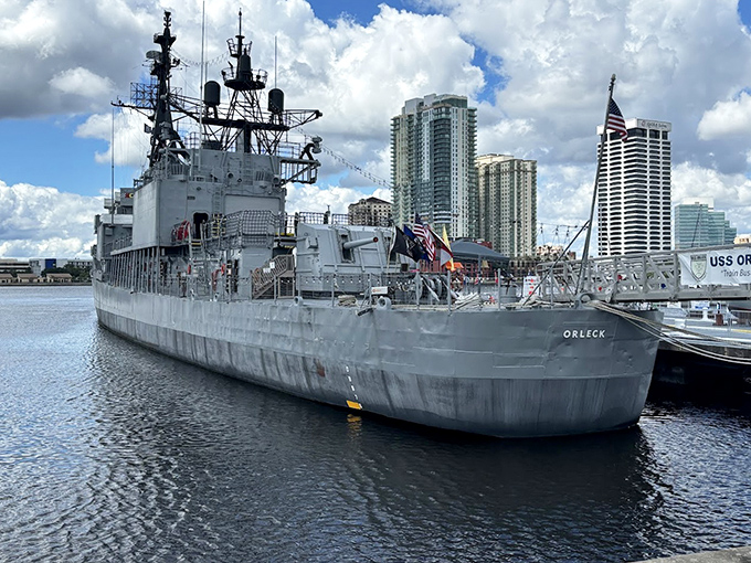 The USS Orleck stands sentinel on Jacksonville's waterfront, its gray silhouette a striking contrast to Florida's typically colorful landscape.