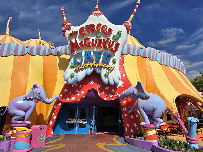 The vibrant yellow and red striped tent beckons with whimsical elephant sentries &ndash; a visual appetizer before the main course of wonder inside.