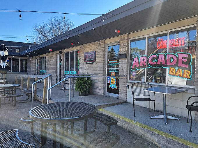 The unassuming stone facade of Coin Slot Arcade Bar hides a neon-lit wonderland within, like finding a secret level in your favorite game.