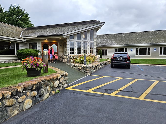 The welcoming exterior of Boone's Long Lake Inn beckons hungry travelers with its rustic charm and stone pathways &ndash; a log cabin cathedral to carnivorous delights.