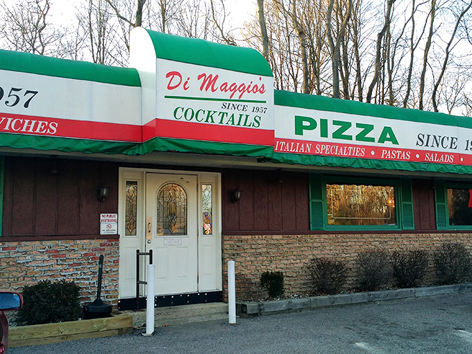 Exterior: The iconic red, white, and green awning of Di Maggio's stands as a beacon of Italian comfort food since 1957, promising delicious memories before you even step inside.