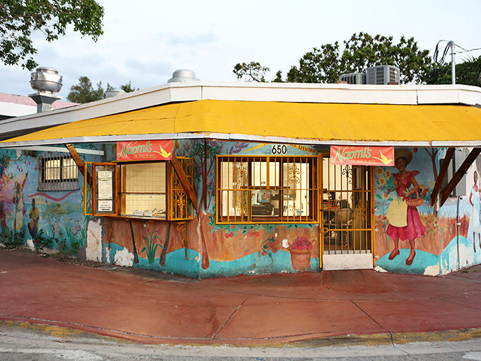 A vibrant yellow awning crowns this corner gem in Little Haiti, where colorful murals tell Caribbean stories before you've even tasted a bite.