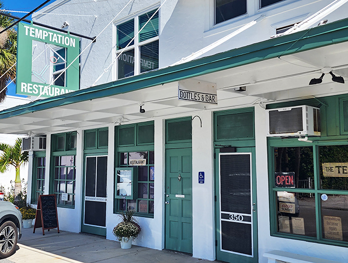 The unassuming white facade with seafoam green accents houses culinary treasures that belie its modest exterior. Florida's best-kept seafood secret hides in plain sight.