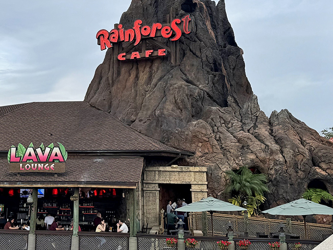 The iconic volcano exterior of Rainforest Cafe erupts with personality, promising wild adventures before you even step inside.