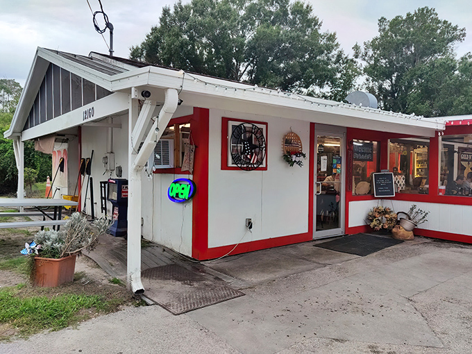 The humble exterior belies the flavor explosion waiting inside this red-trimmed roadside wonder.