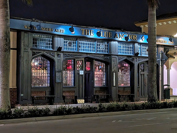 The Blue Anchor's Tudor facade glows with mysterious invitation at twilight, like a British time machine that landed among Florida's palm trees.