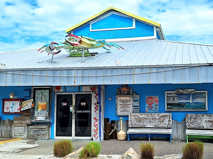 The iconic blue exterior of Crabby Bill's, where giant crabs on the roof serve as both decoration and a promise of deliciousness within.